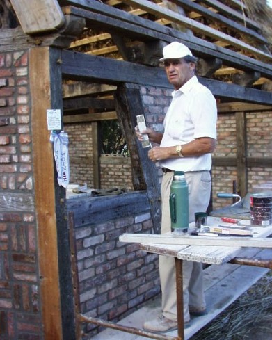 Michael Olk continues laying brick on west wall.